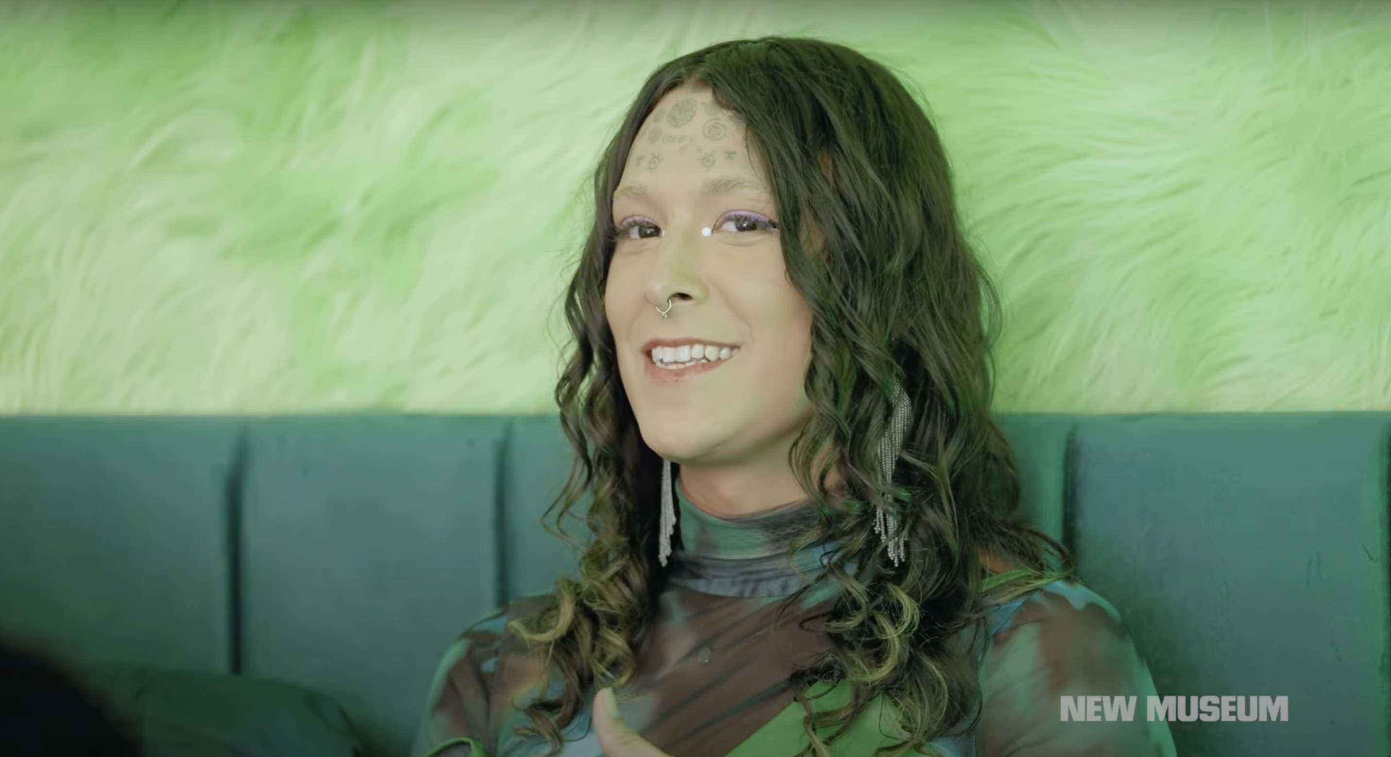 Artist Jade Guanaro Kuriki-Olivo (Puppies Puppies) seated in her ...