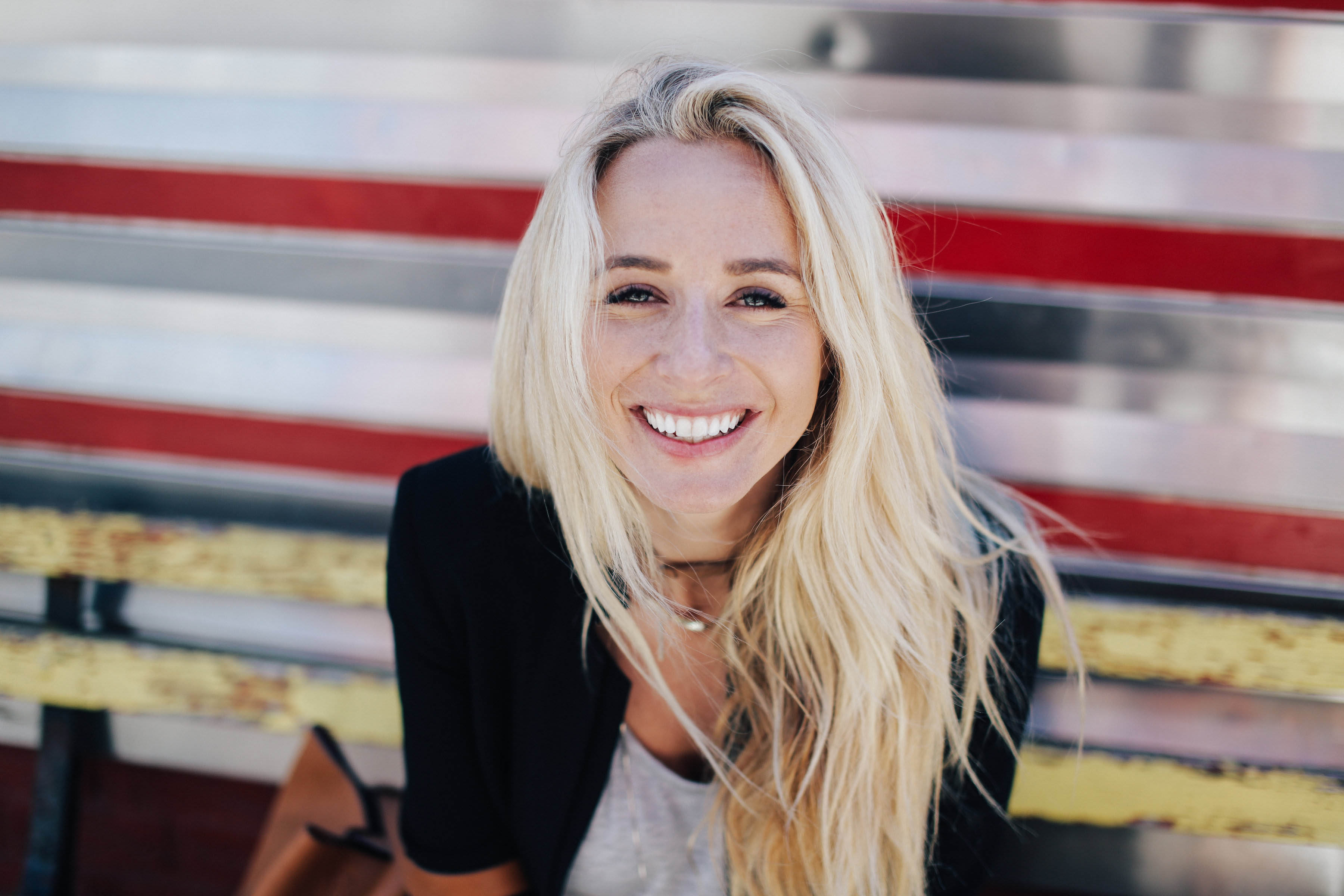 bryony smiling with a black blazer and long blonde hair